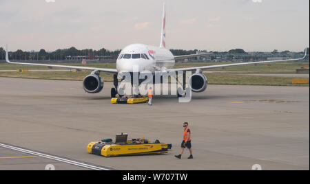 A Mototok remote control electric tug moves a British Airways plane at ...