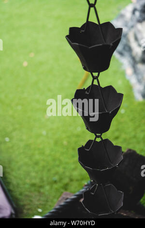 A closeup of a traditional Japanese rain chain (kusaridoi Stock Photo ...