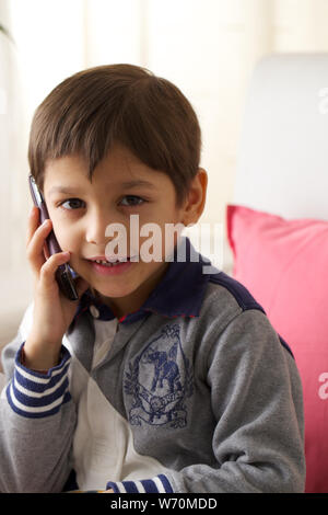 Cute boy using cell phone Stock Photo - Alamy