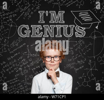 Thinking child boy with ginger hair portrait Stock Photo - Alamy