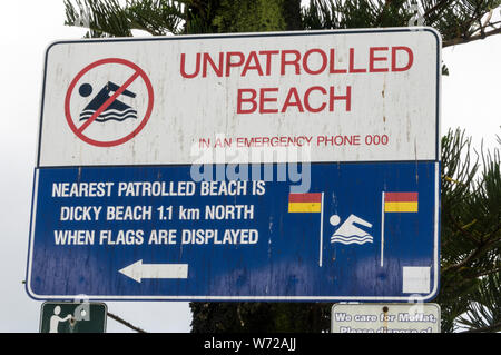 Danger sign on beach near Whitehaven marina and harbour on the west ...