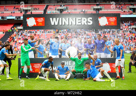 Manchester City players celebrate with the trophy during the FA ...