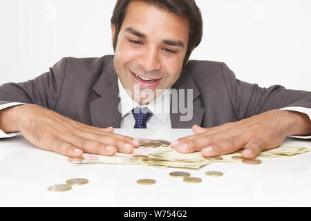 Indian businessman grabbing money Stock Photo - Alamy
