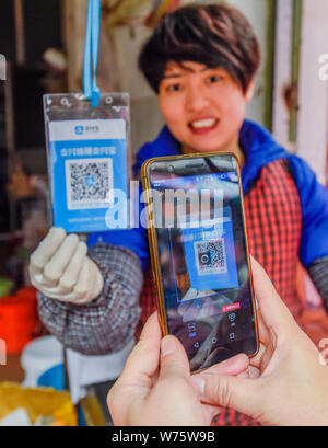 --FILE--A customer have the QR code on her smartphone scanned via ...
