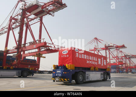 An automated guided vehicle (AGV) of Shanghai International Port Group ...