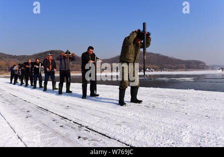 Workers collect ice blocks in Jiangbin Park to build an ice and snow ...