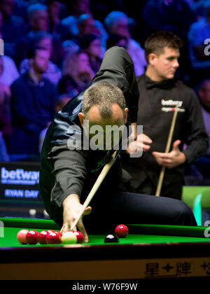 Ryan Day of Wales plays a shot to John Higgins of Scotland in their ...