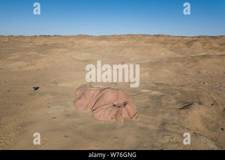 Aerial view of a giant 3D sleeping baby sculpture on display on the ...