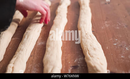 Step by step. Brading dough to bake fresh challah bread Stock Photo - Alamy