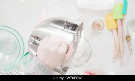 Step by step. Flat lay. Mixing royal icing in electric kitchen mixer ...