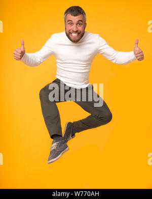 excited man jumping and triumphing on blue Stock Photo - Alamy