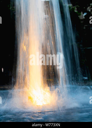 Splashes of colorful fountain. Water illuminated in diverse colors ...