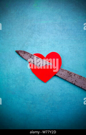 Heart stabbed with a knife. Broken heart concept isolated on white 3d ...