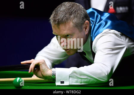 Gerard Greene of Northern Ireland plays a shot to Mark Williams of ...