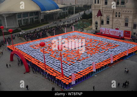 Students holding umbrellas line up to create the world's biggest human ...