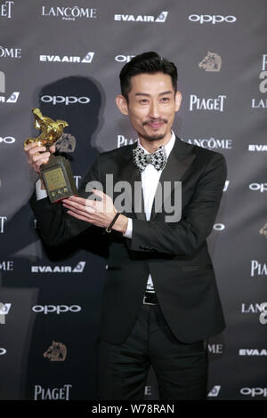 Taiwanese actor Chen Chu-sheng poses with his trophy of the Best ...