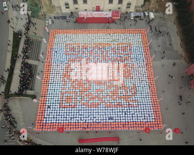 Students holding umbrellas line up to create the world's biggest human ...