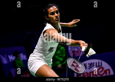 Han Yue of China returns a shot to Sayaka Takahashi of Japan during the ...