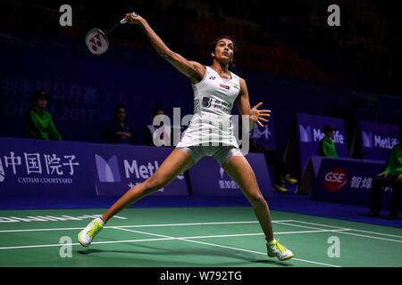 Han Yue of China returns a shot to Sayaka Takahashi of Japan during the ...