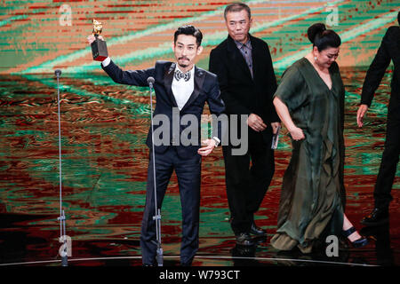 Taiwanese actor Chen Chu-sheng poses with his trophy of the Best ...