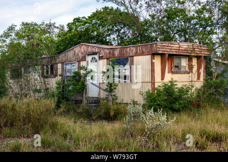 An old, run-down caravan has been parked on a lawn for the rest of its ...