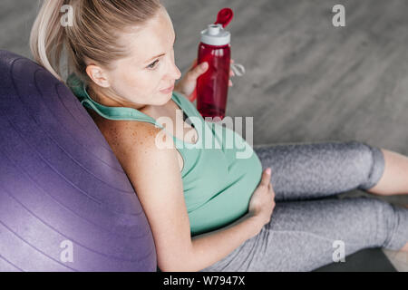 Pregnant woman, lotus and exercise ball with white background for ...