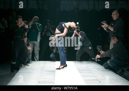 Chinese contortionist Liu Teng performs during an attempt to set a new ...