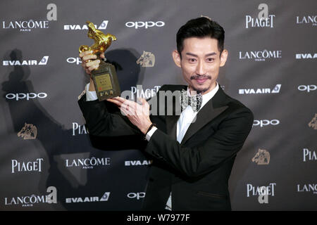 Taiwanese actor Chen Chu-sheng poses with his trophy of the Best ...