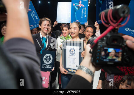 Chinese contortionist Liu Teng poses with a Guinness World Record ...