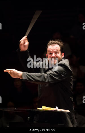 Latvian conductor Andris Nelsons performs at a concert in Shenzhen city ...