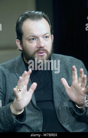 Latvian conductor Andris Nelsons, right, talks with Chinese TV host Cao ...