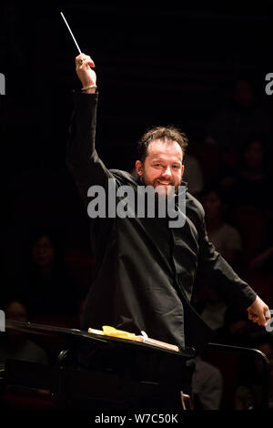 Latvian conductor Andris Nelsons performs at a concert in Shenzhen city ...