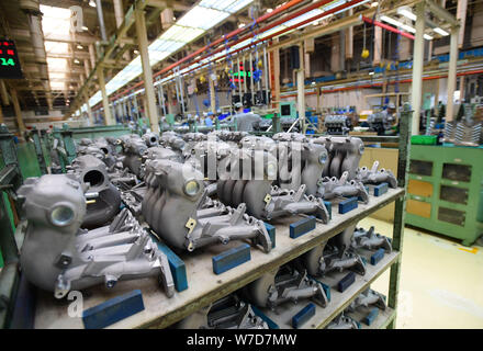 --FILE--Chinese workers assemble engines for autos at a plant of ...