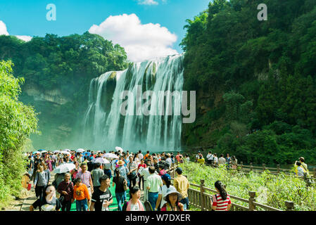 Tourists visit the Huangguoshu Waterfall scenic area in Guiyang City ...