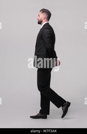 rear view. pensive businessman stepping forward . isolated on white ...