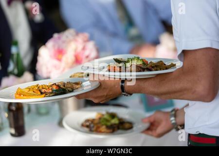picture of a waiter who serves Italian antipasti in an outdoor ...
