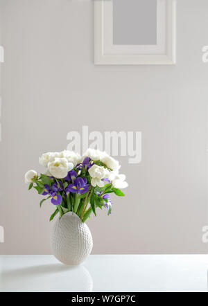 Vase with iris flowers on dining table served for International Women's ...