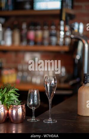 Brandy glasses with ice on wooden background Stock Photo - Alamy