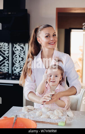 Happy loving family are preparing bakery together. Mother and children ...