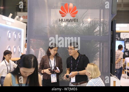 --FILE--Chinese employees are seen at a Huawei mobile phone store in ...