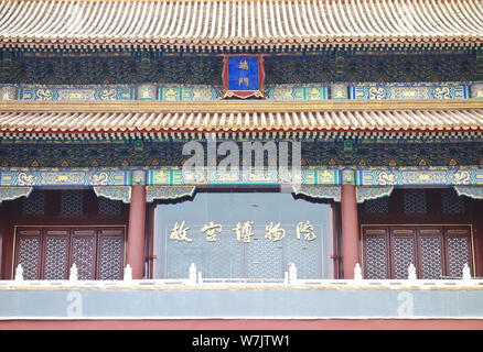A glass wall with Chinese characters "Gugong Bowuguan", which means ...