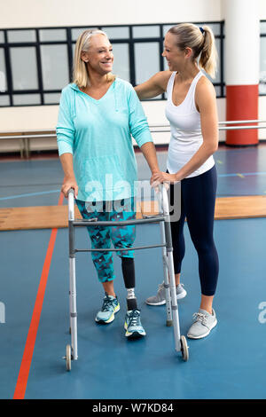Senior woman on a walk. A disabled woman looking at flowers Stock Photo ...