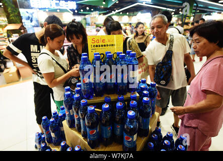 Customers shop at a supermarket in Hangzhou, Zhejiang province, China ...
