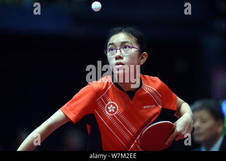 Ng Wing Lam of Hong Kong serves as she and Lee Ka Yee compete against ...