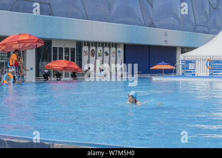 Local residents go swimming in the 25 meter-long and 15 meter-wide ...