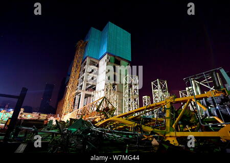 The deformed steel structure of a collapsed tower crane is seen at a ...