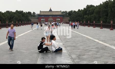 Chinese visitors lie on the Danbi Bridge in the Temple of Heaven Park ...