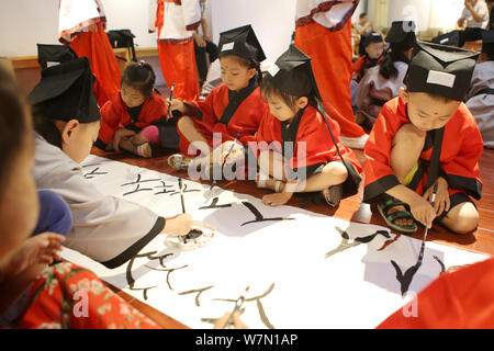 Students write the Chinese character "Ren," meaning "Human" in English ...