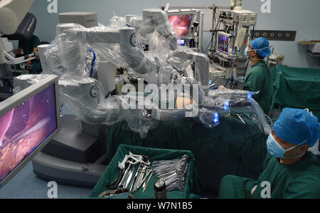 A surgical robot equipped with cameras is carrying out its first ...