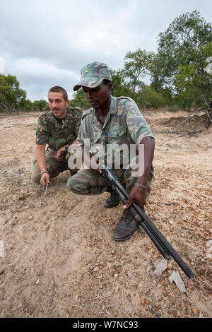 Anti-poaching patrol unit on horseback with Mount Kenya in background ...